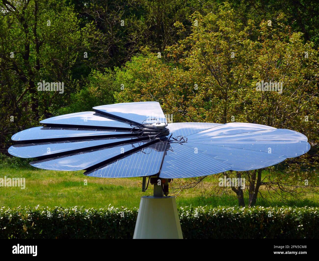 Circular flower shaped rotating solar panel system. tracing the sun`s movement. Intelligent and ...